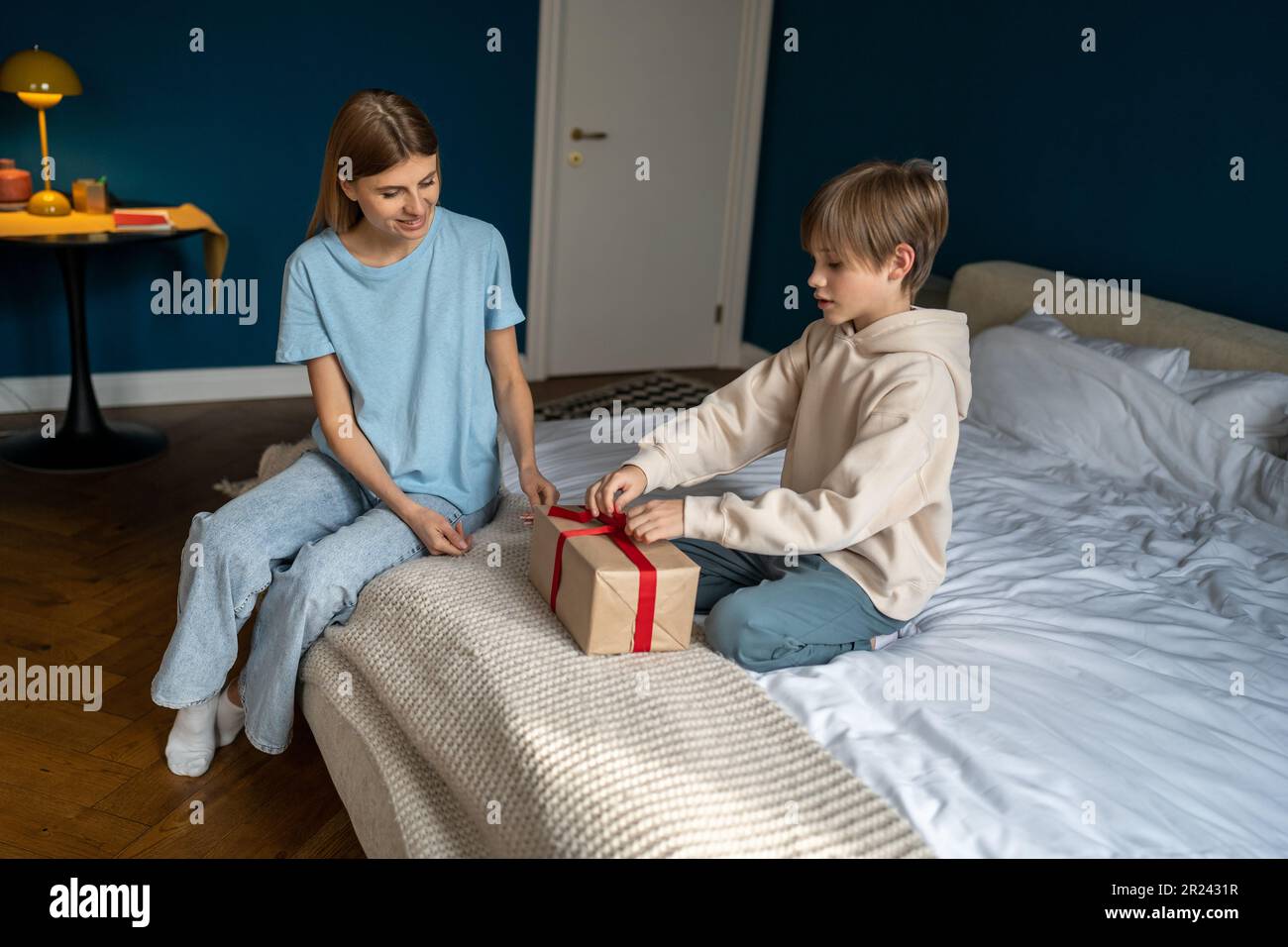 Happy kid son unwrapping gift box feeling excited getting present from ...