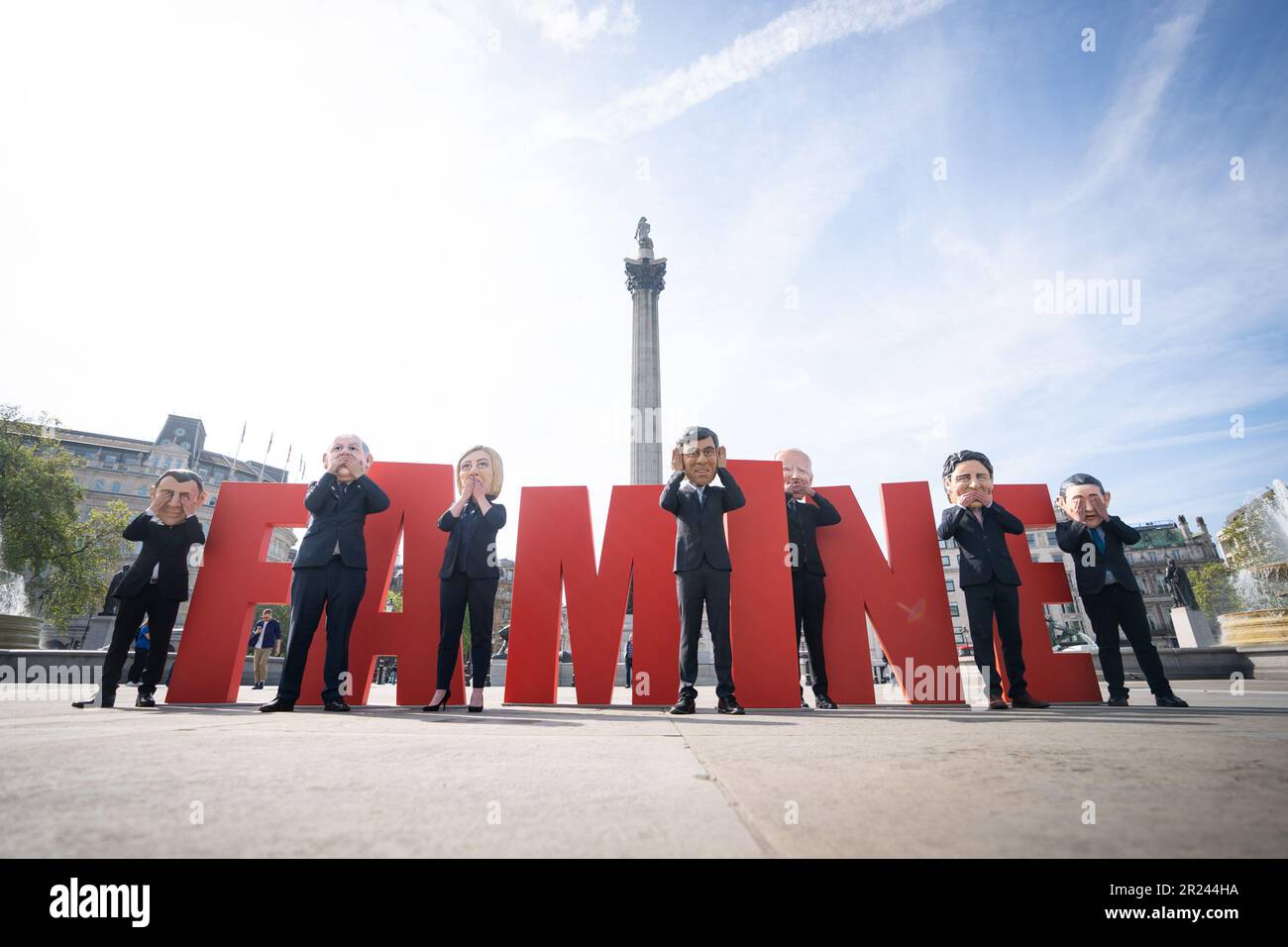 Oxfam activists wearing 'big heads' of G7 leaders during a ...