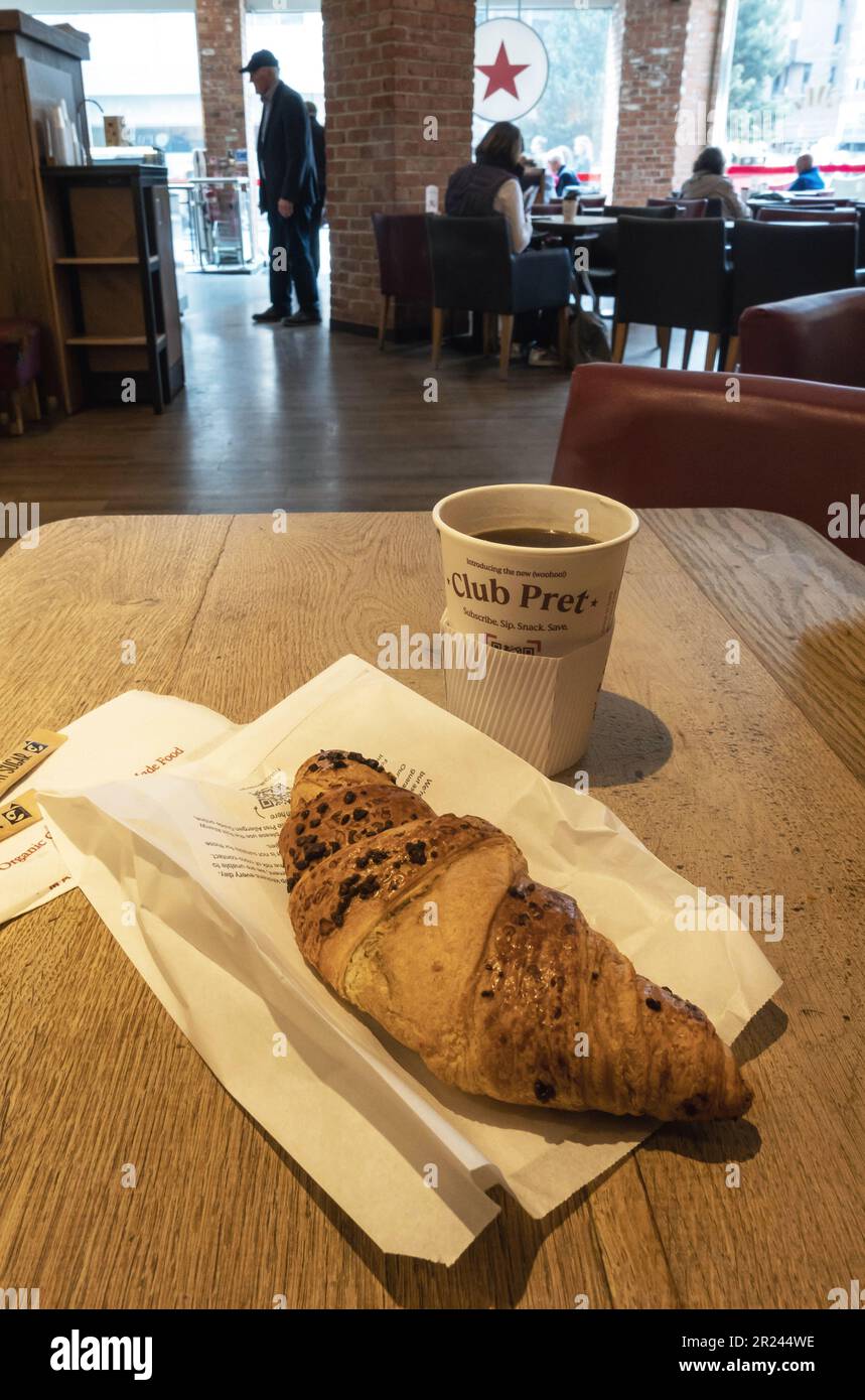 Pret A Manger table with chocolate croissant and black coffee Stock ...