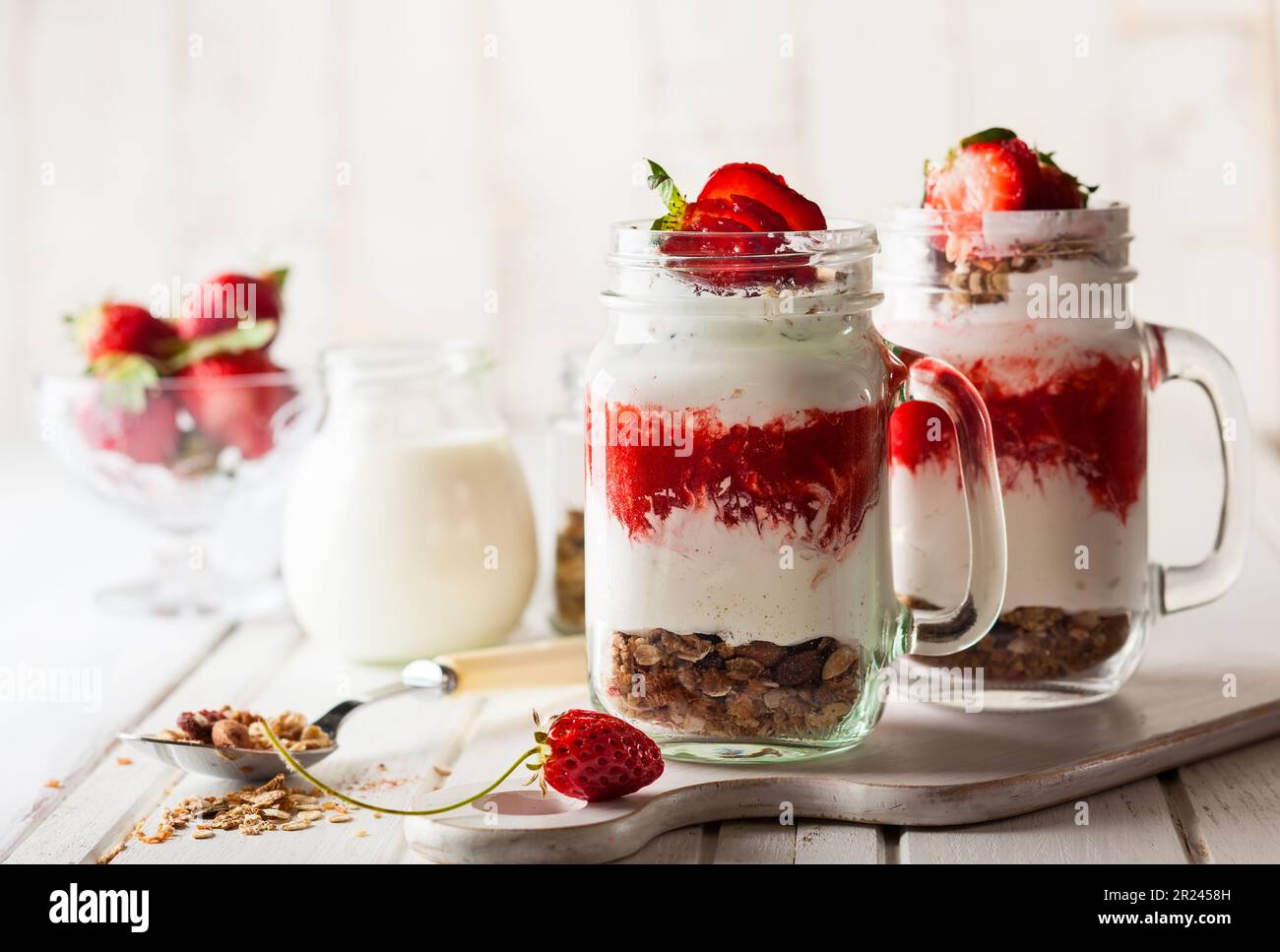 Healthy breakfast in a Mason jar with yogurt, strawberry puree and ...