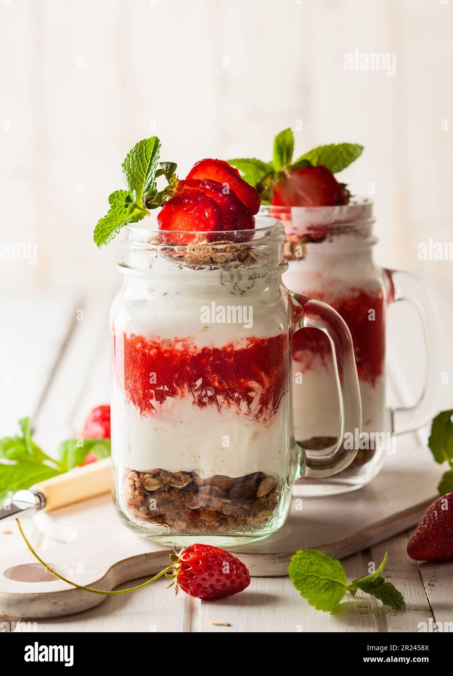 Healthy breakfast in a Mason jar with yogurt, strawberry puree and ...
