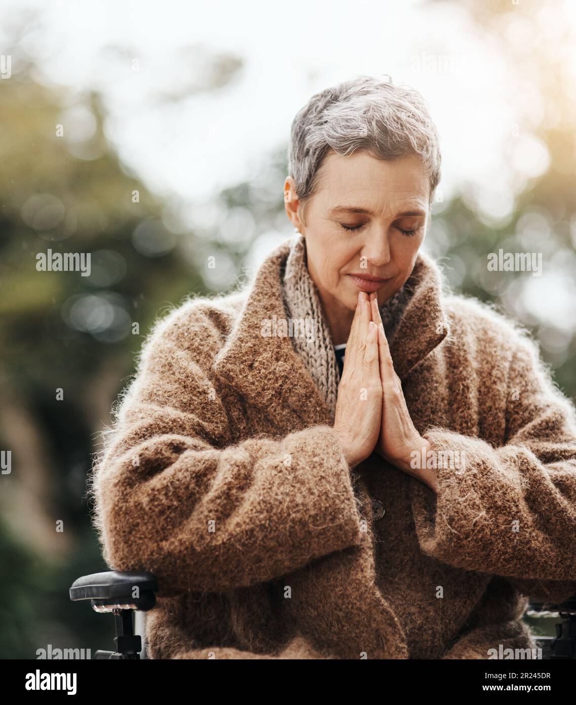 Old woman in wheelchair, praying in garden with worship and God, faith ...