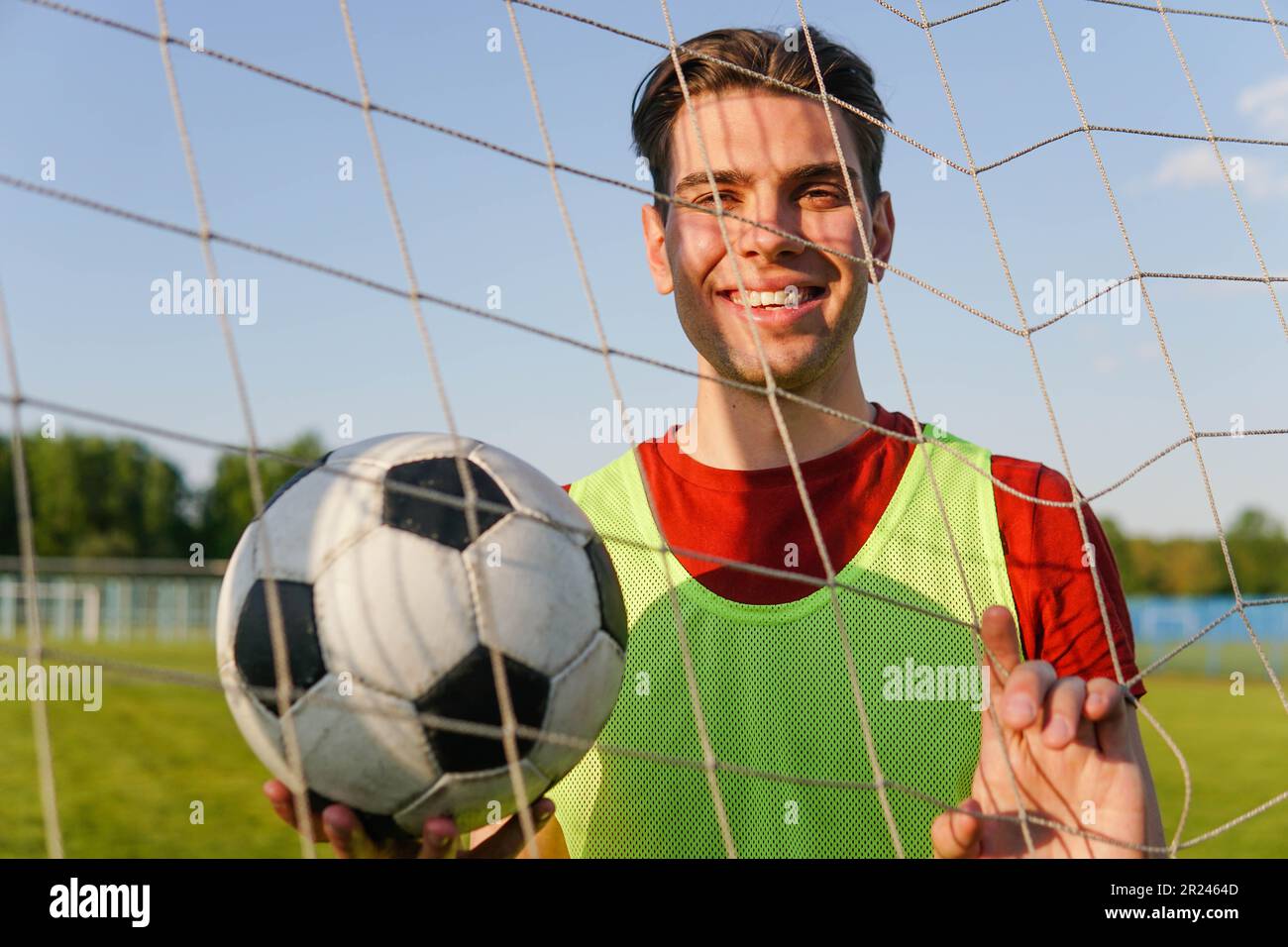 Teen guy holding soccer ball hi-res stock photography and images - Alamy