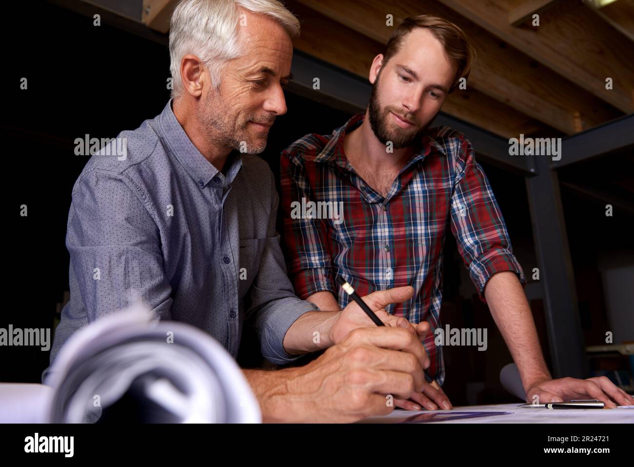 Learning the tricks of the trade. two male architects working together ...