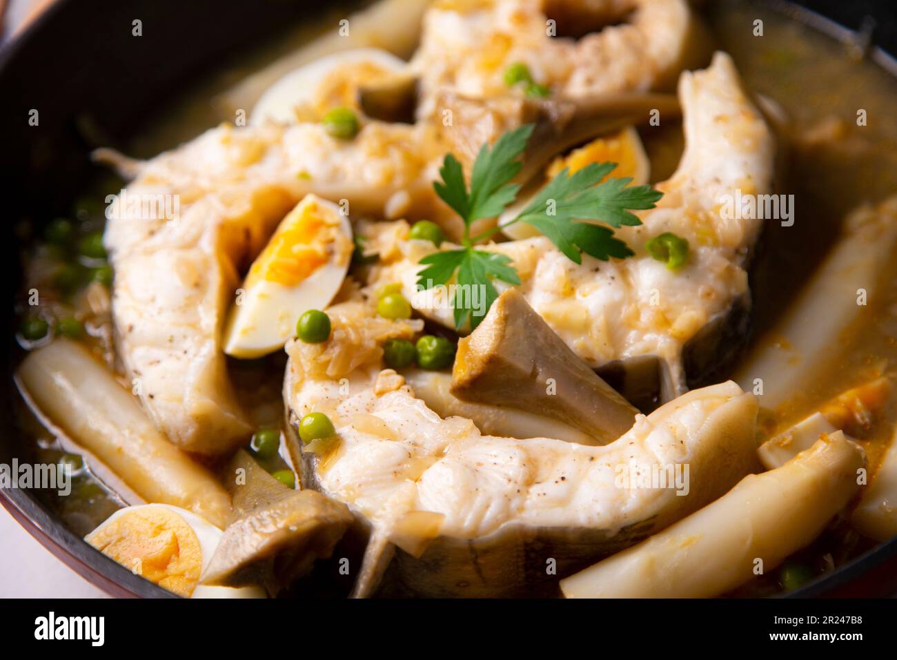 Conger eel stew cooked with hard-boiled egg, artichokes and peas Stock ...