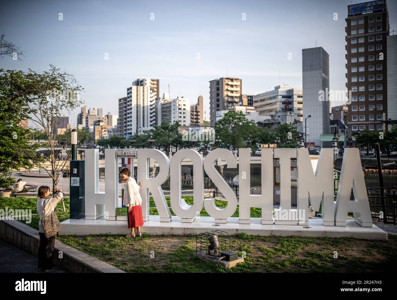 Hiroshima, Japan. 17th May, 2023. Two passers-by stand in front of a ...