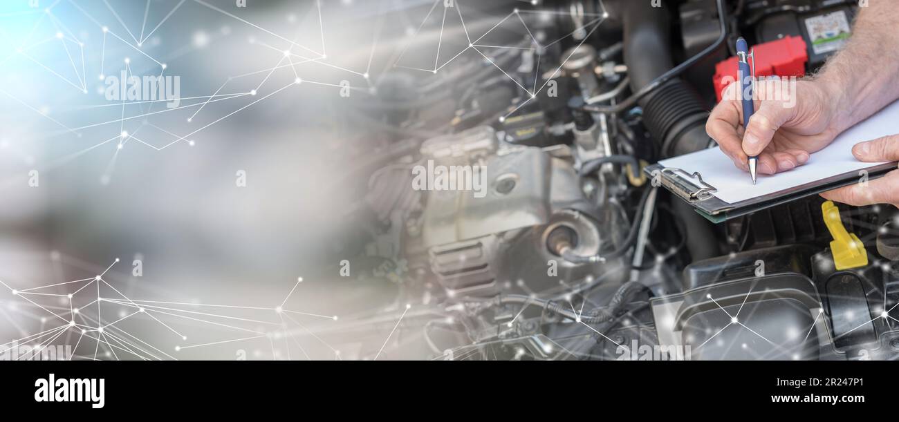 Car mechanic checking a car engine and writing on clipboard; panoramic ...