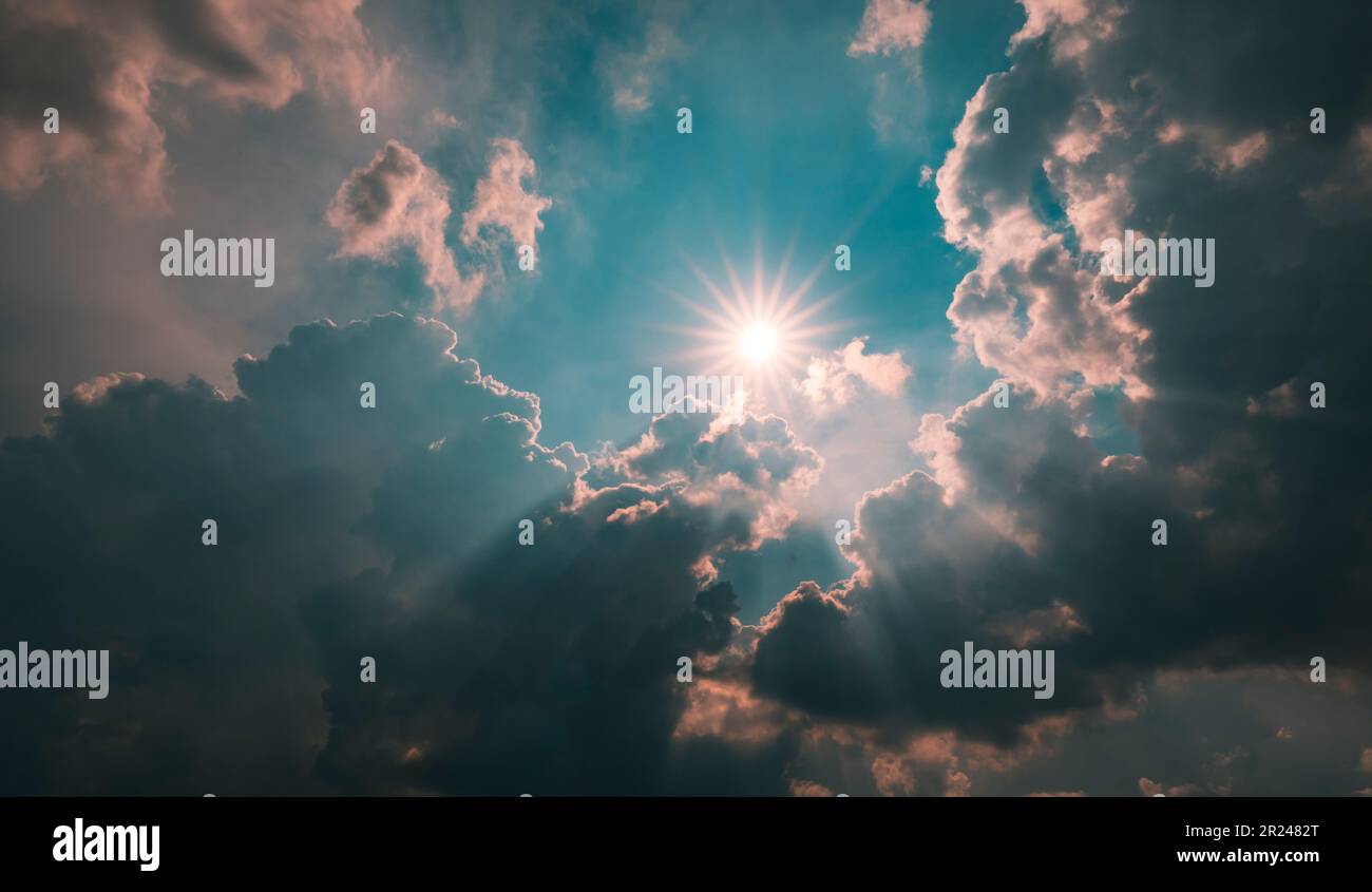 A cloud-filled sky, with a bright beam of sunlight breaking through the ...