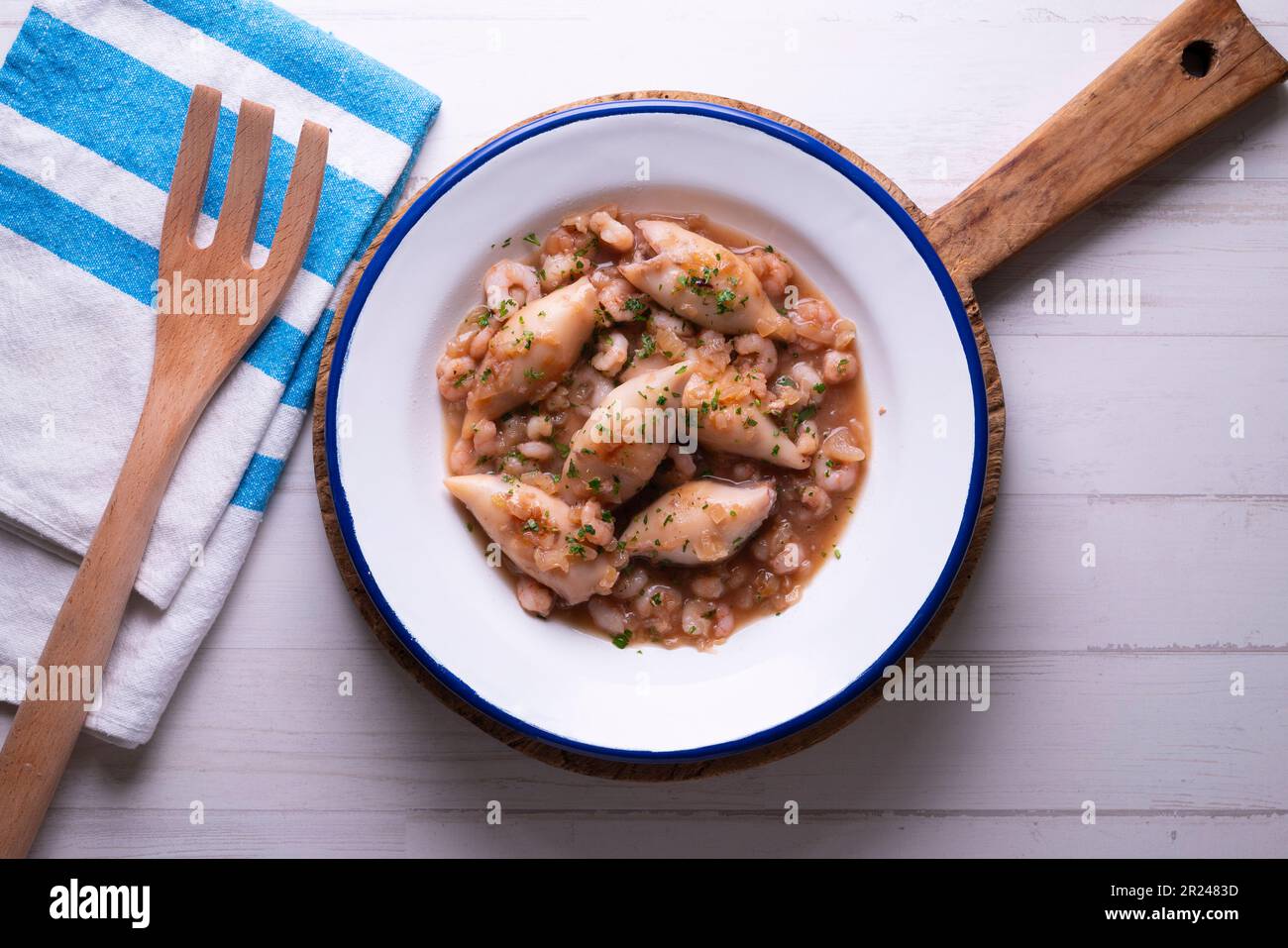 Baby Squid stew with potatoes and prawns. Traditional Spanish recipe ...