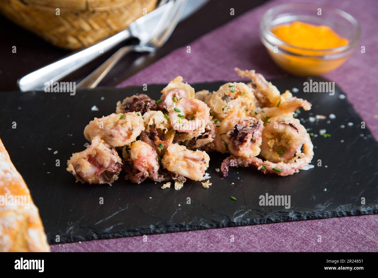 Spanish tapa of fried squid Stock Photo - Alamy