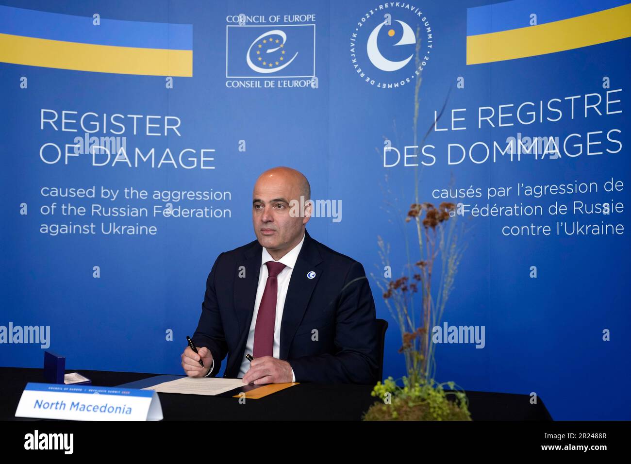 North Macedonia's Prime Minister Dimitar Kovachevski prepares to sign a ...