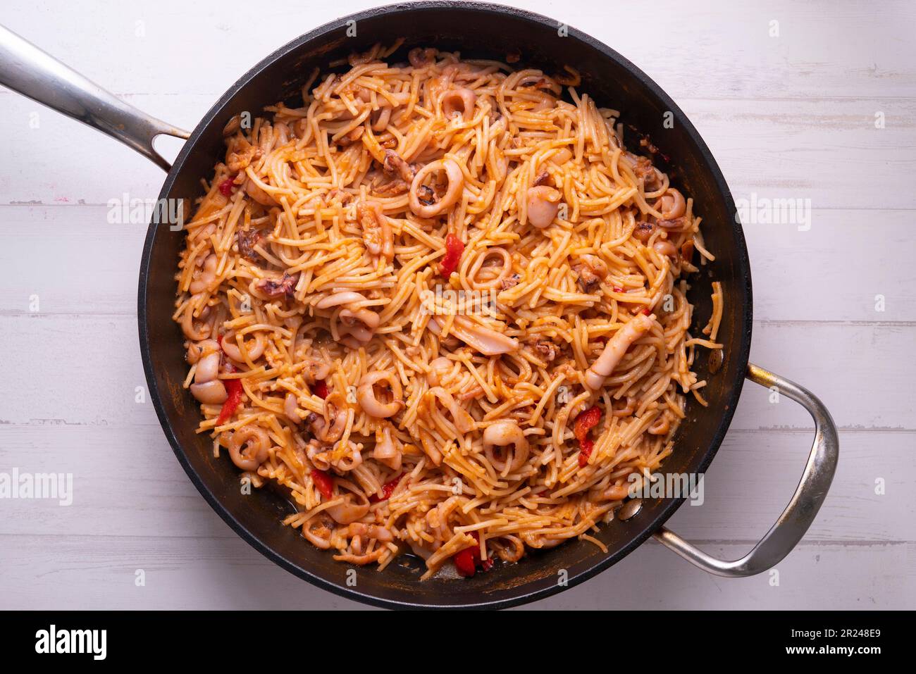 Fideua paella with squid. Traditional Spanish recipe Stock Photo - Alamy