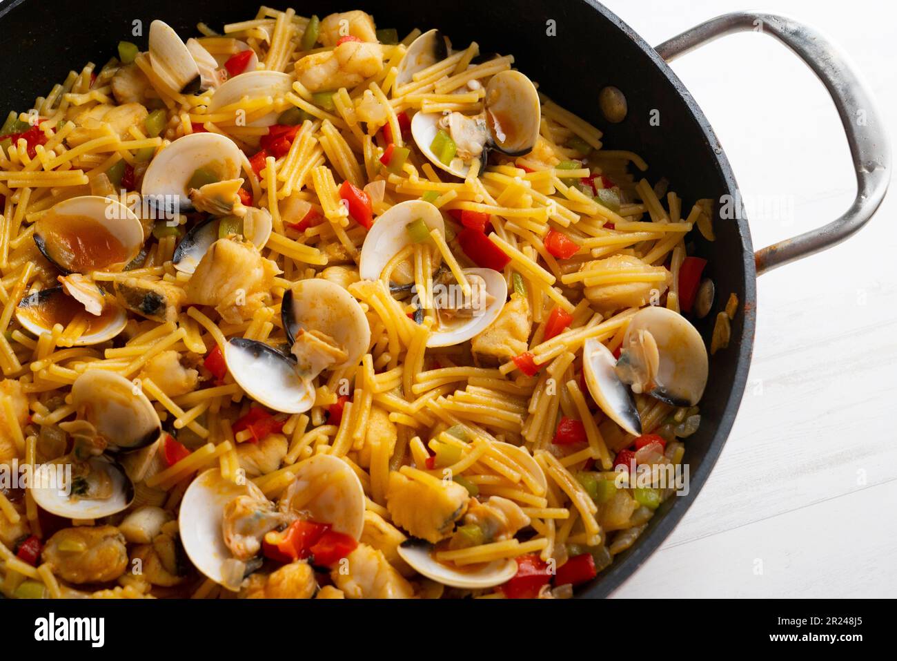 Fideua paella with shellfish, monkfish and clams. Traditional Spanish ...