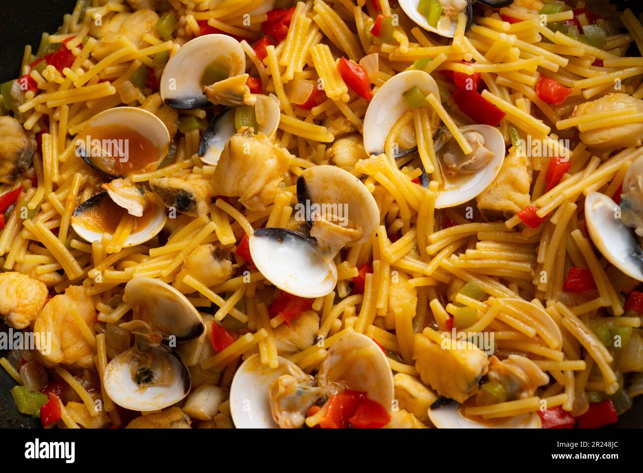 Fideua paella with shellfish, monkfish and clams. Traditional Spanish ...