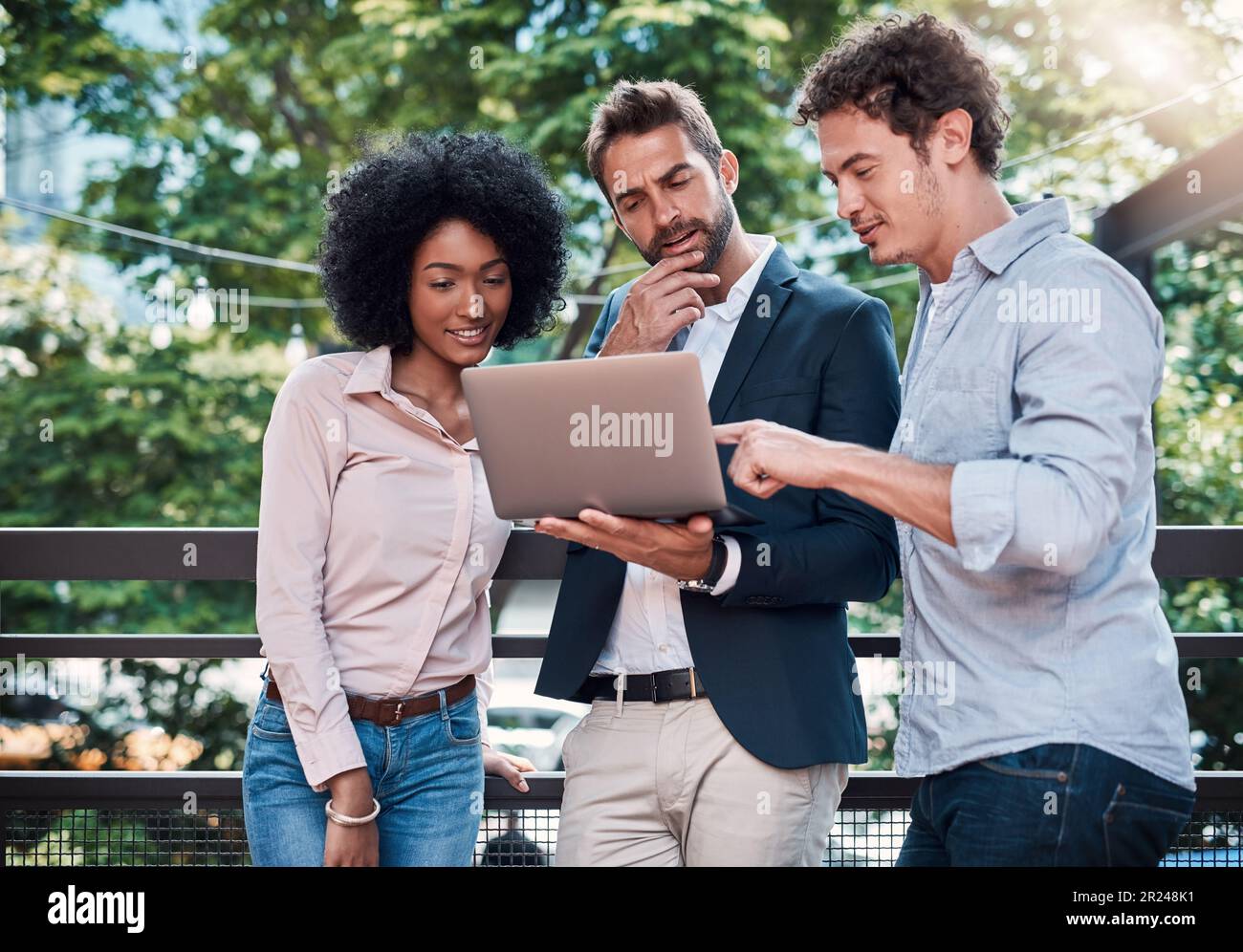 Teamwork, laptop and business people together outdoor, working and ...