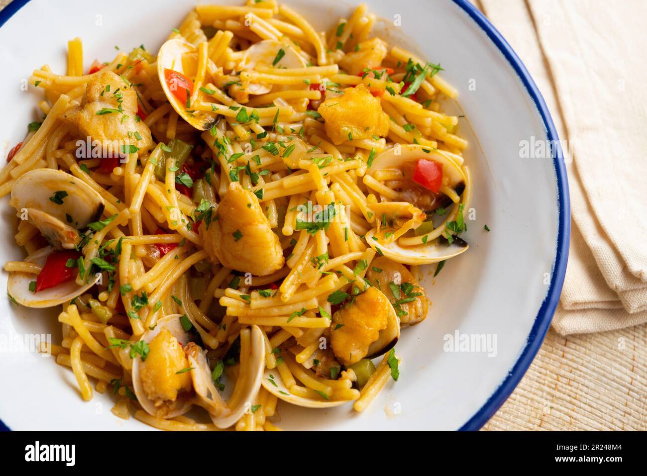 Fideua paella with shellfish, monkfish and clams. Traditional Spanish ...