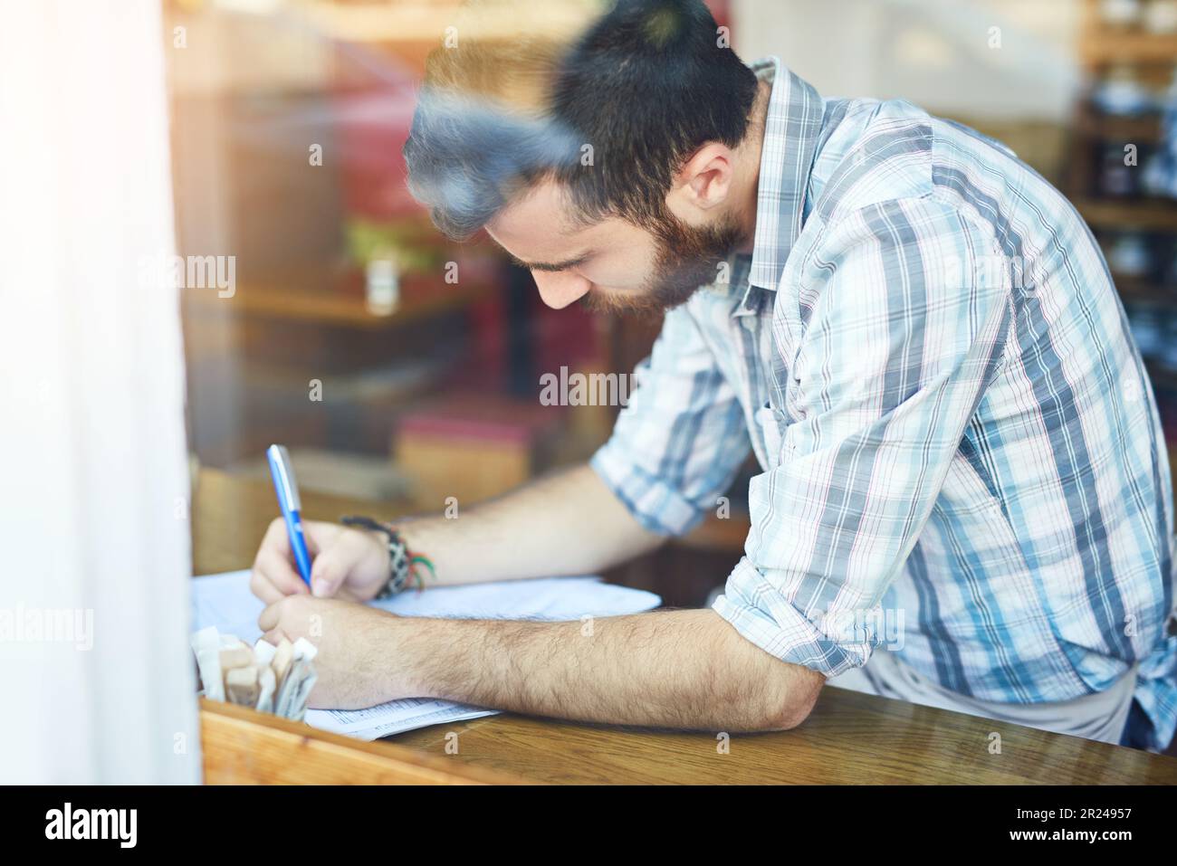 Therell always be paperwork. a shop owner doing some paperwork Stock ...