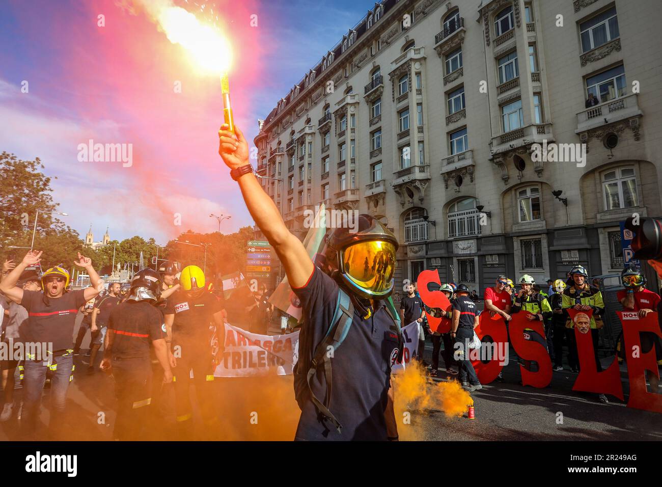 Madrid, Spain. 16th May, 2023. A firefighter holds a fire flare as he ...