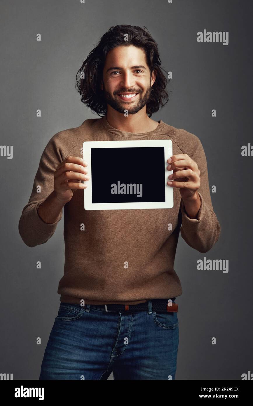 Portrait, tablet screen and smile of man with mockup in studio isolated ...