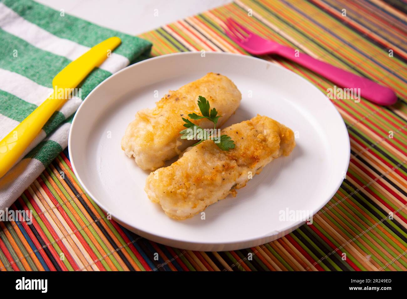 Hake fillet battered with tomato sauce Stock Photo - Alamy