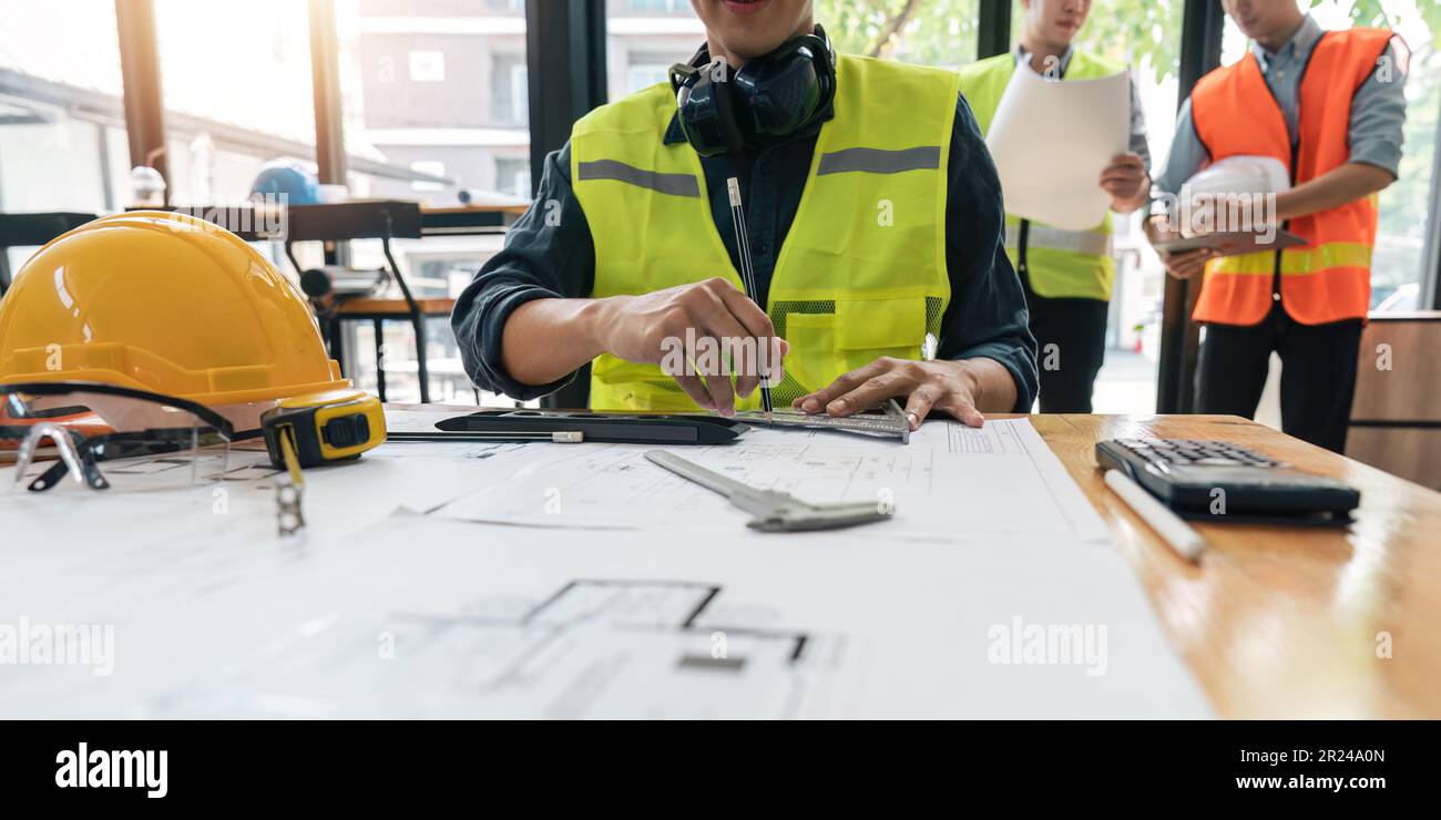engineer working on blueprints and construction plans. Building ...