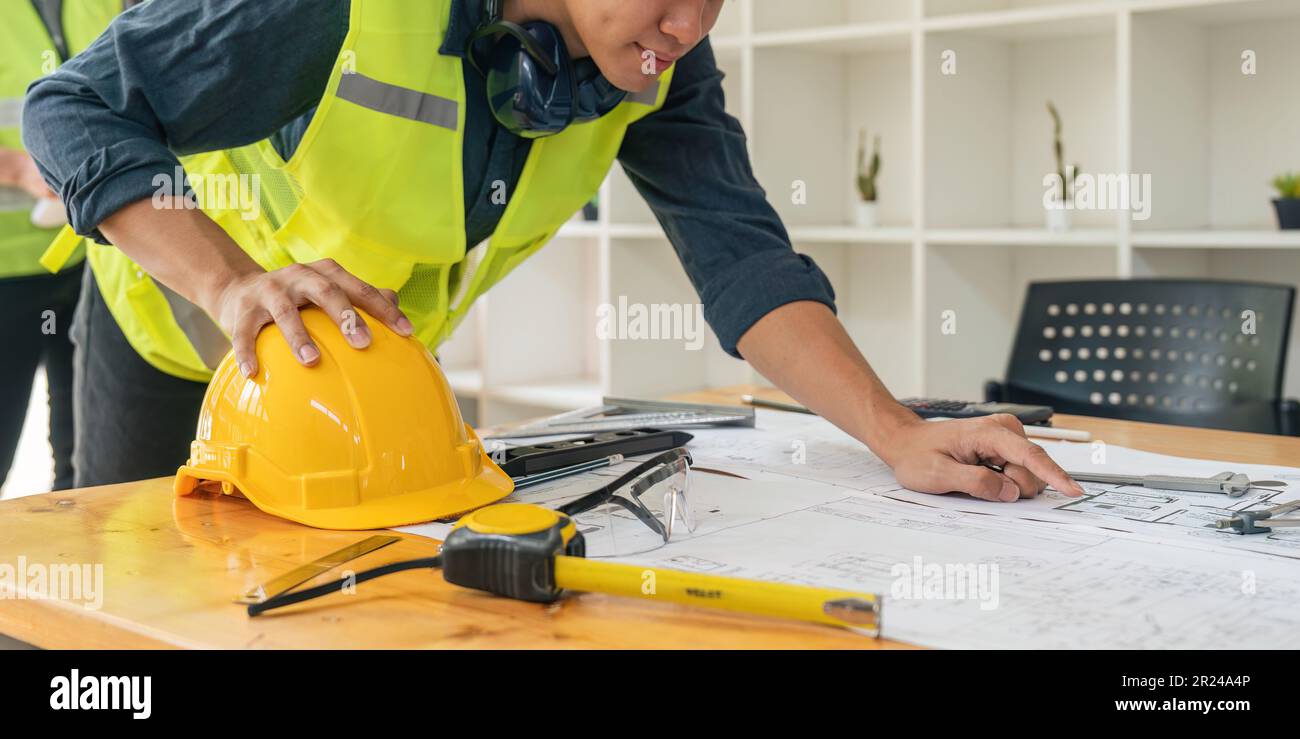 engineer working on blueprints and construction plans. Building ...