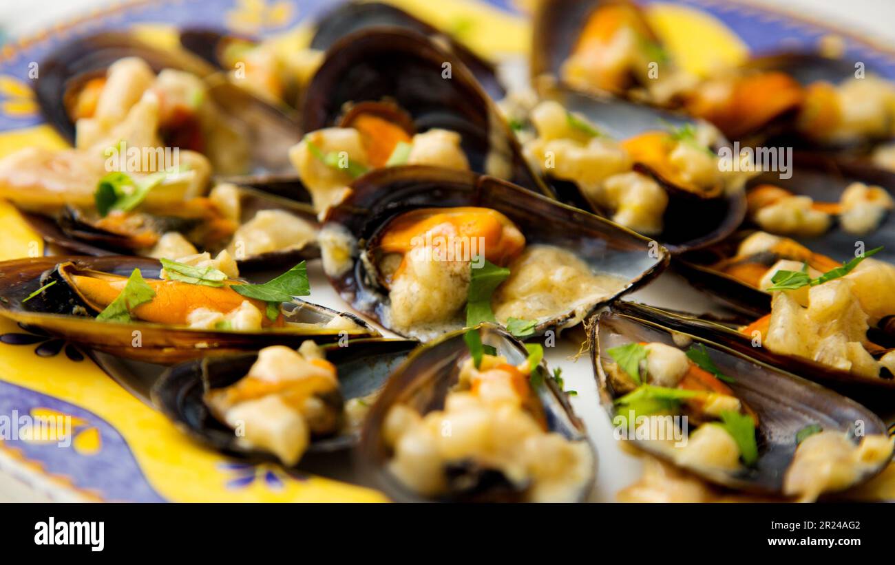 Steamed mussels with vegetables and sauce. Traditional Spanish tapa ...