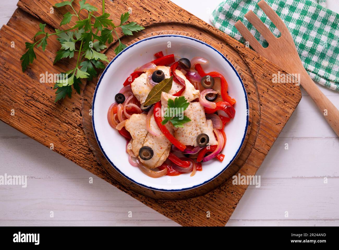 White fish filet cooked with black olives and red peppers Stock Photo ...