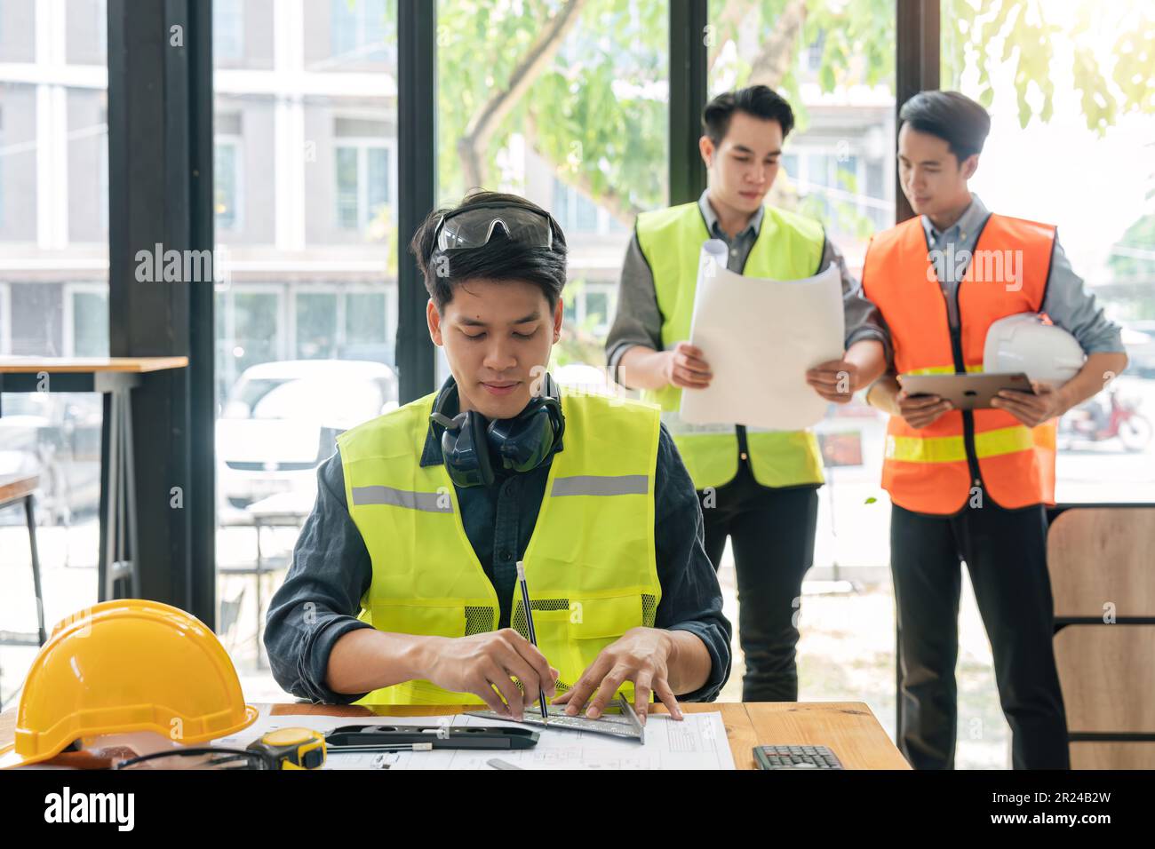 engineer working on blueprints and construction plans. Building ...