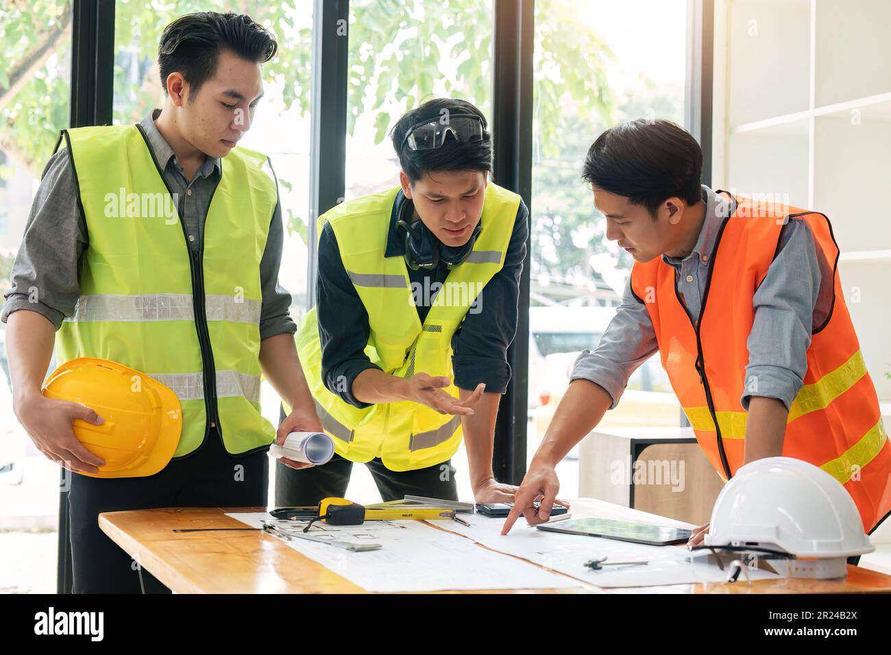 engineer people meeting working and pointing at a blueprint in office ...