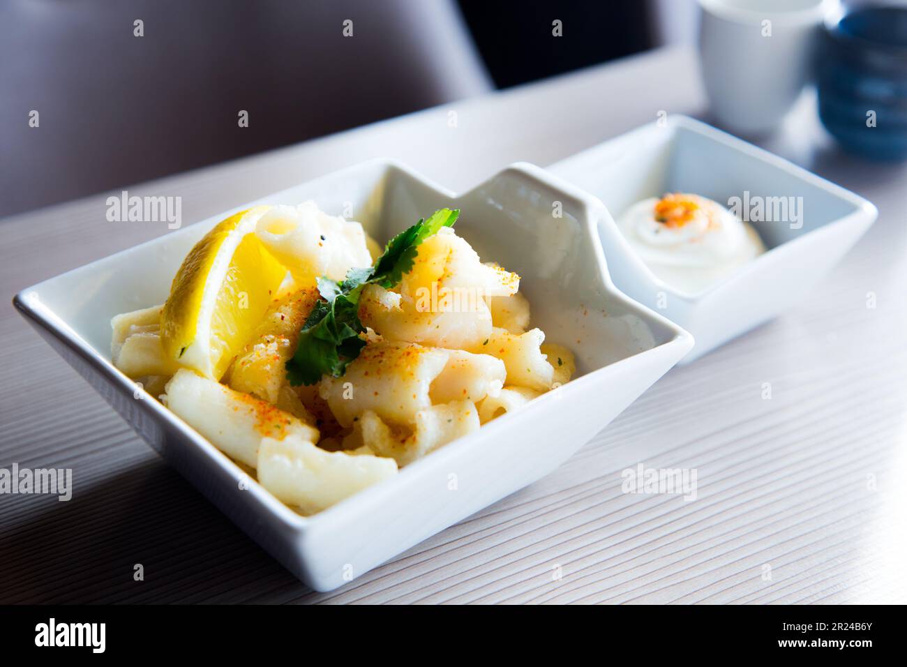 Rabas al ajillo. Rabas cooked with garlic. Squid leg tapa served with ...