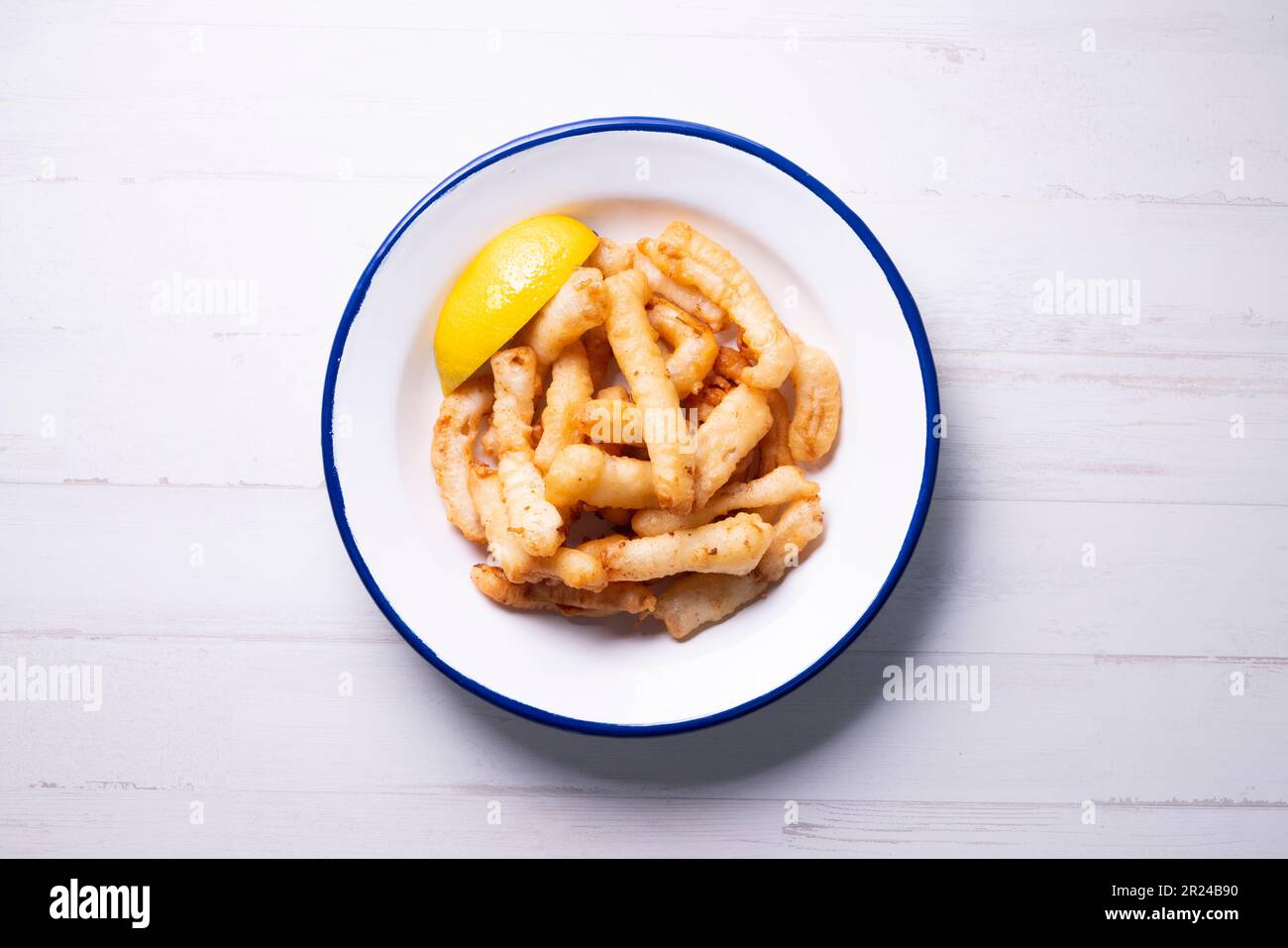 Rabas a la romana Breaded squid leg tapa served with lemon. Traditional ...