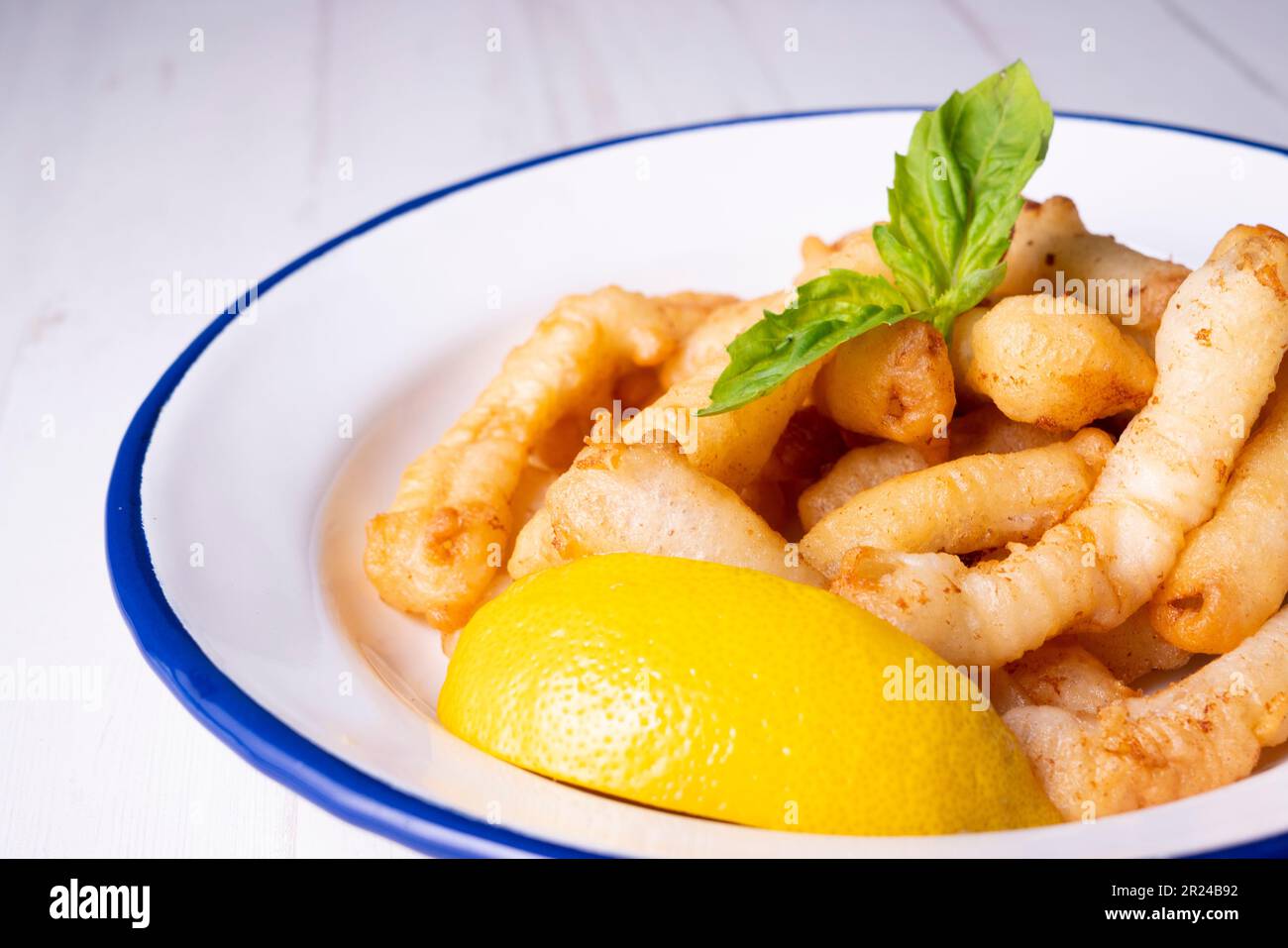 Rabas a la romana Breaded squid leg tapa served with lemon. Traditional ...
