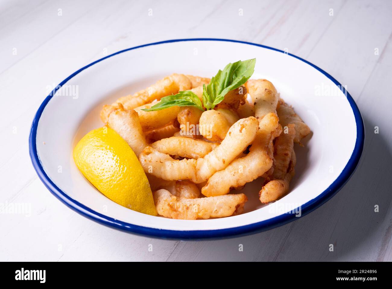 Rabas a la romana Breaded squid leg tapa served with lemon. Traditional ...