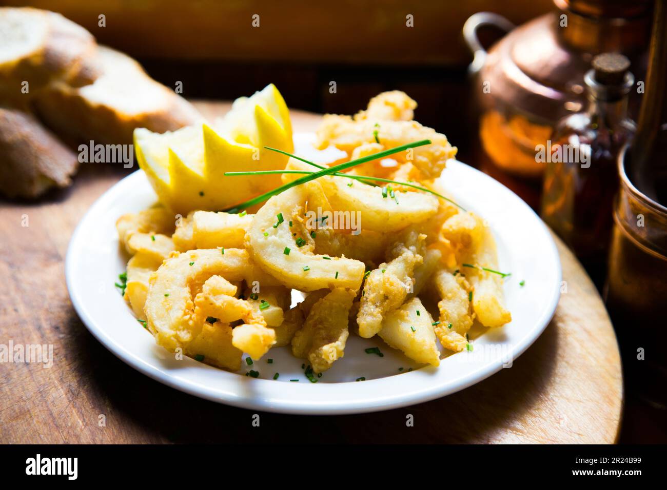 Rabas a la romana Breaded squid leg tapa served with lemon. Traditional ...