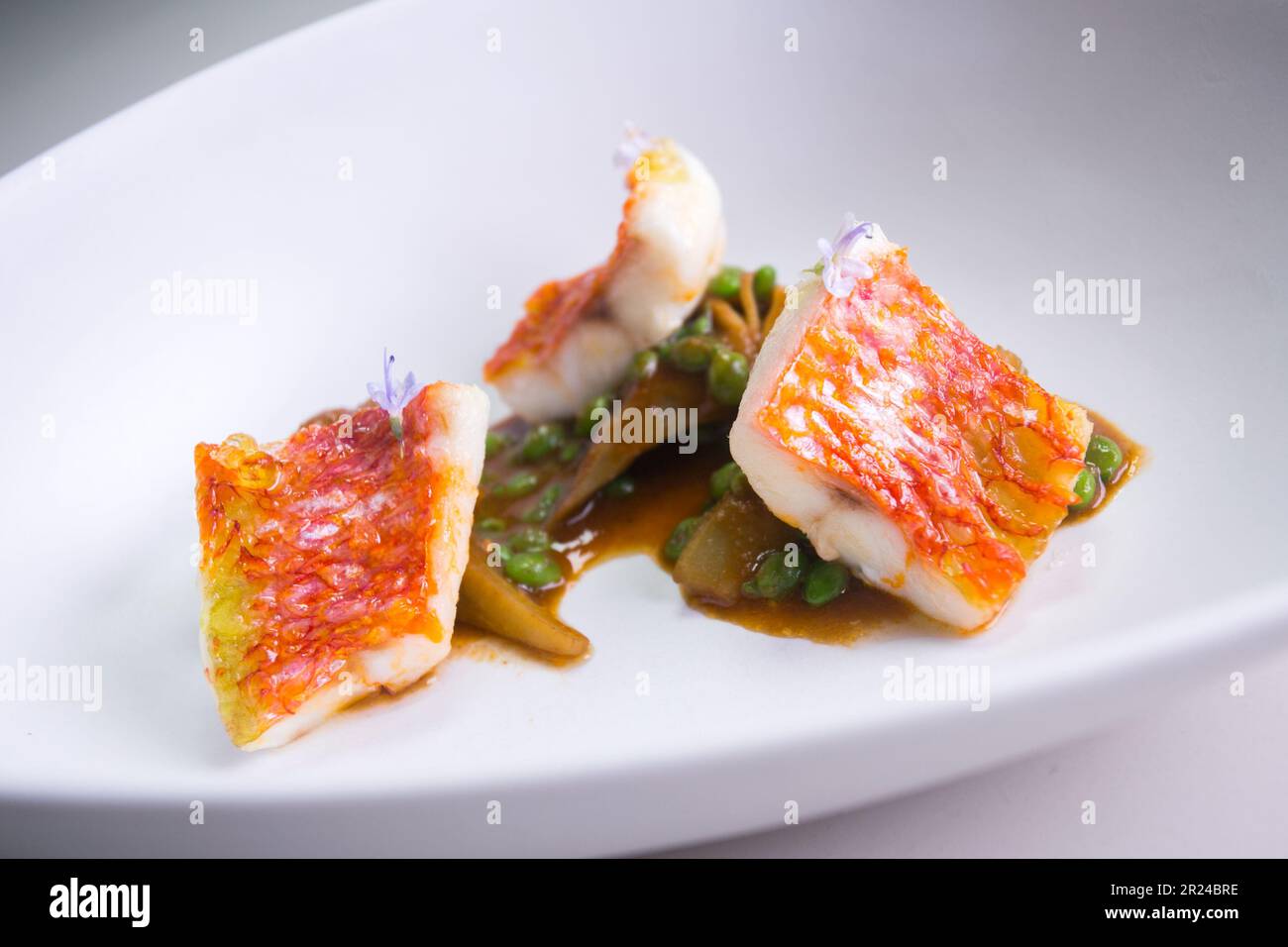 Plate of top quality red mullets cooked in the oven with vegetables in ...