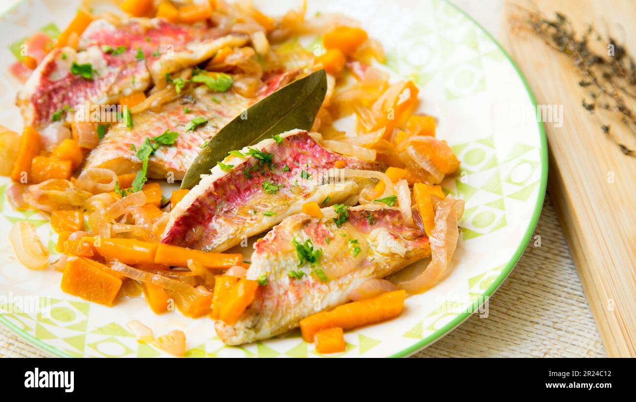 Plate of top quality red mullets cooked in the oven with vegetables in ...