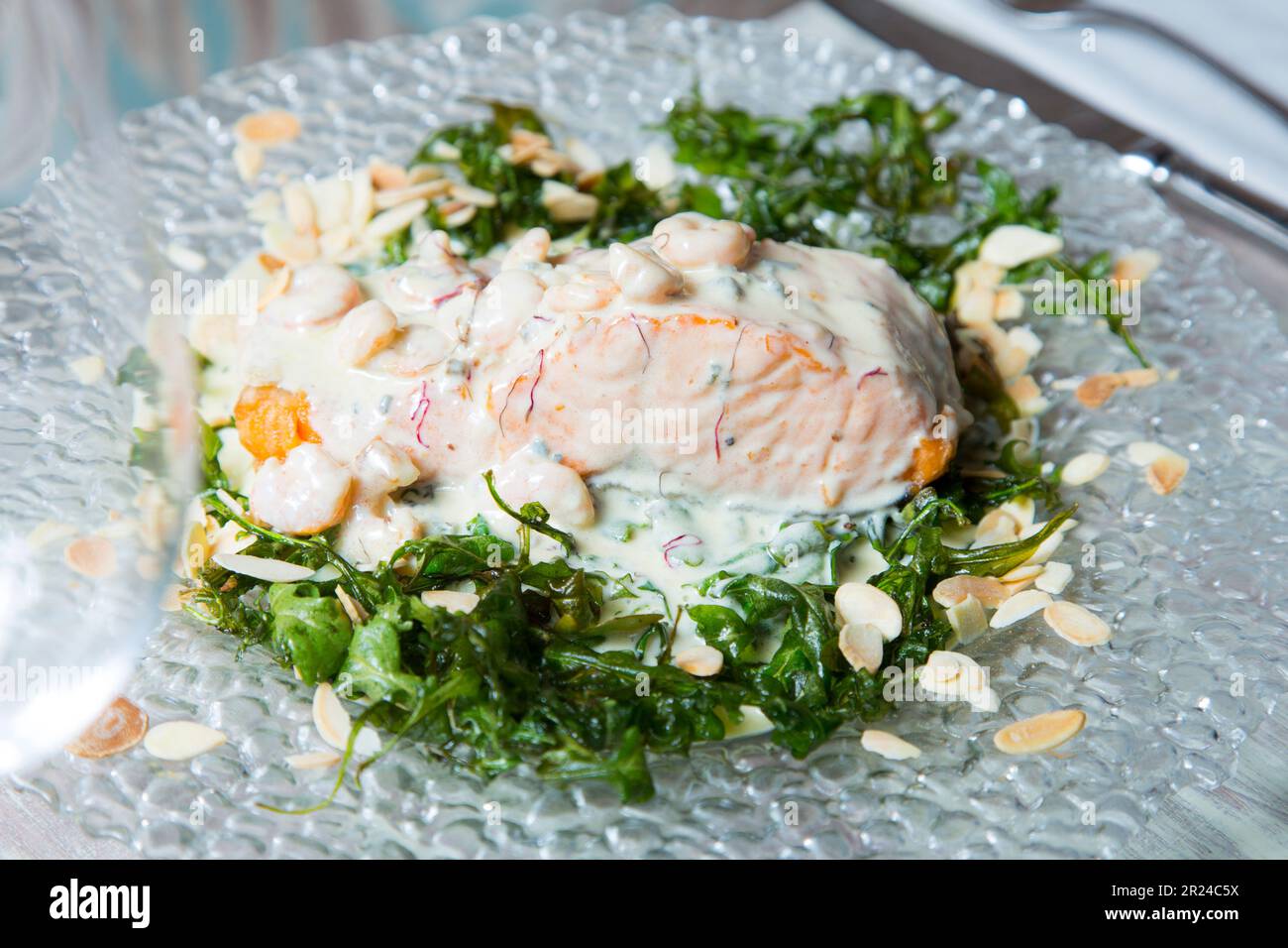 Top quality salmon dish cooked in the oven with white sauce in a luxury ...
