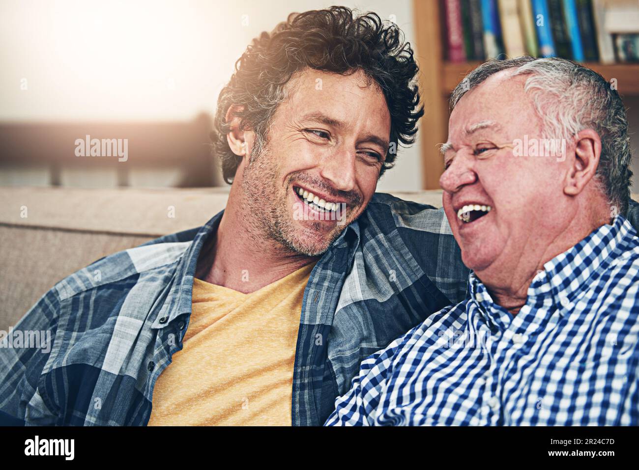 Happy, relax and senior father with son on sofa for bonding, smile and ...