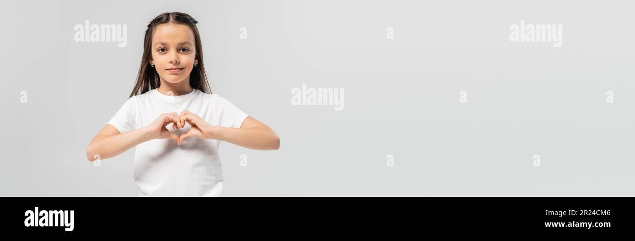 happy preteen girl with long brunette hair standing in white t-shirt ...