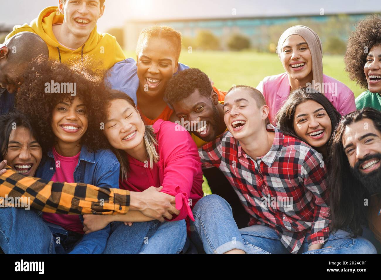 Young diverse people having fun outdoor laughing together - Focus on ...