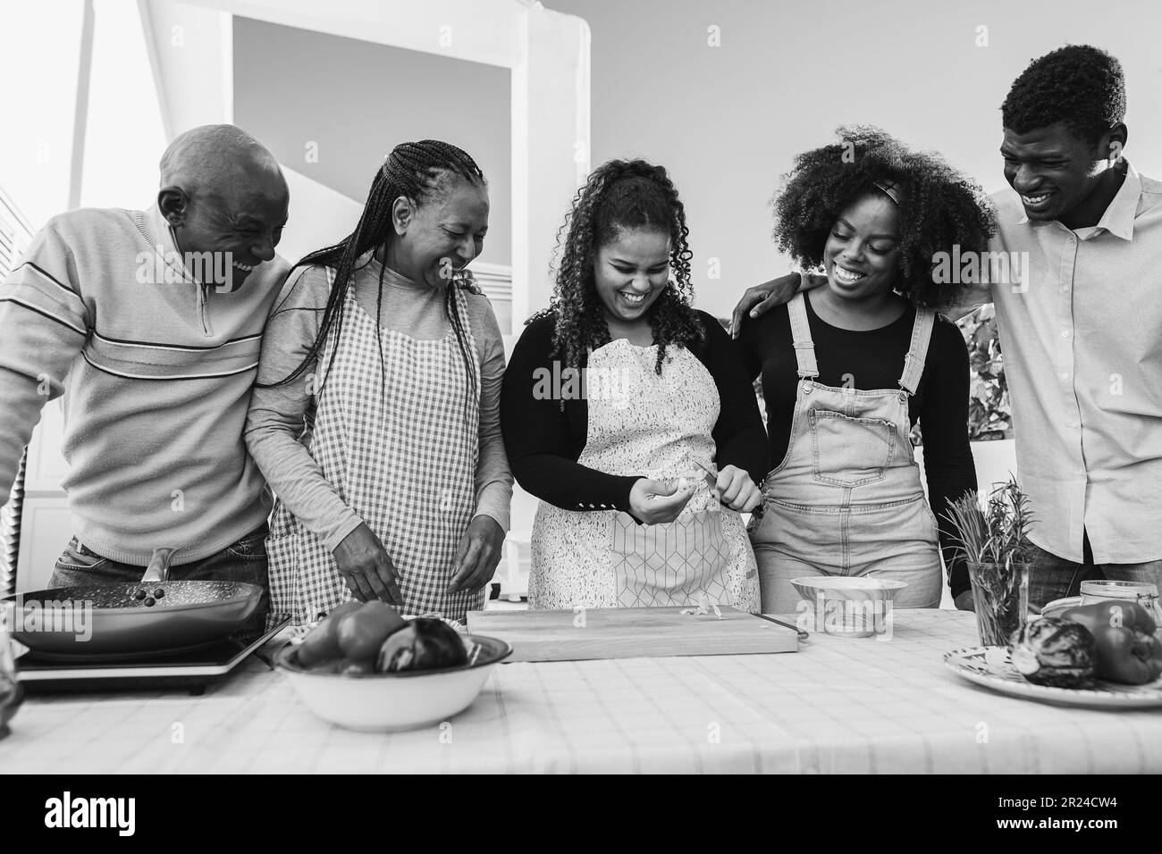 Happy african family cooking together outdoor at home terrace - Focus ...
