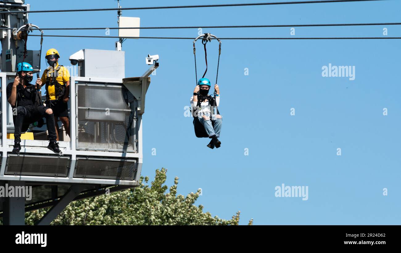 The people in a thrilling airborne activity zipping down a suspended ...