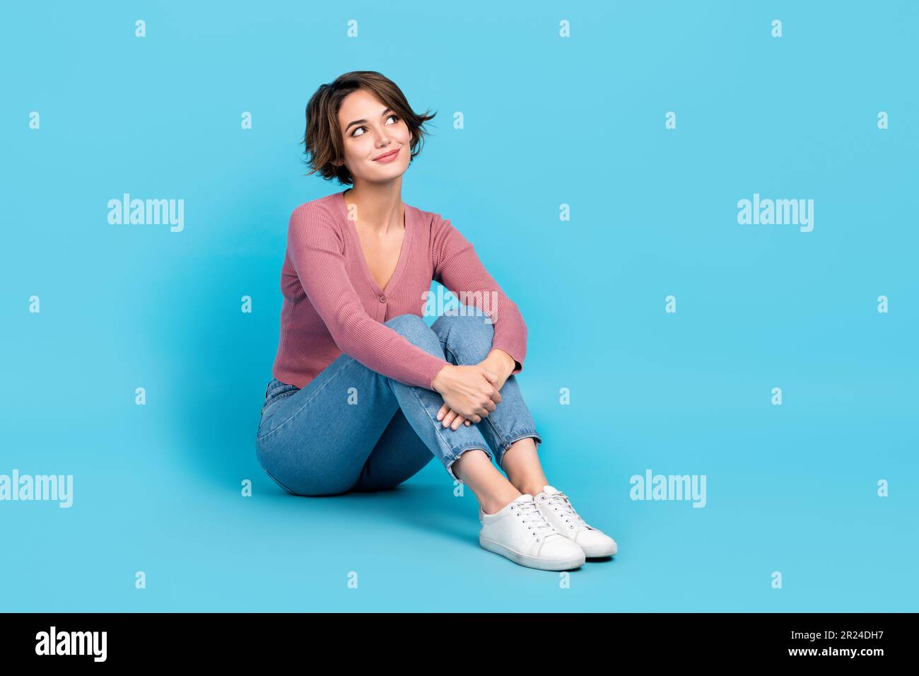 Full length portrait of cute minded person sit floor look empty space ...