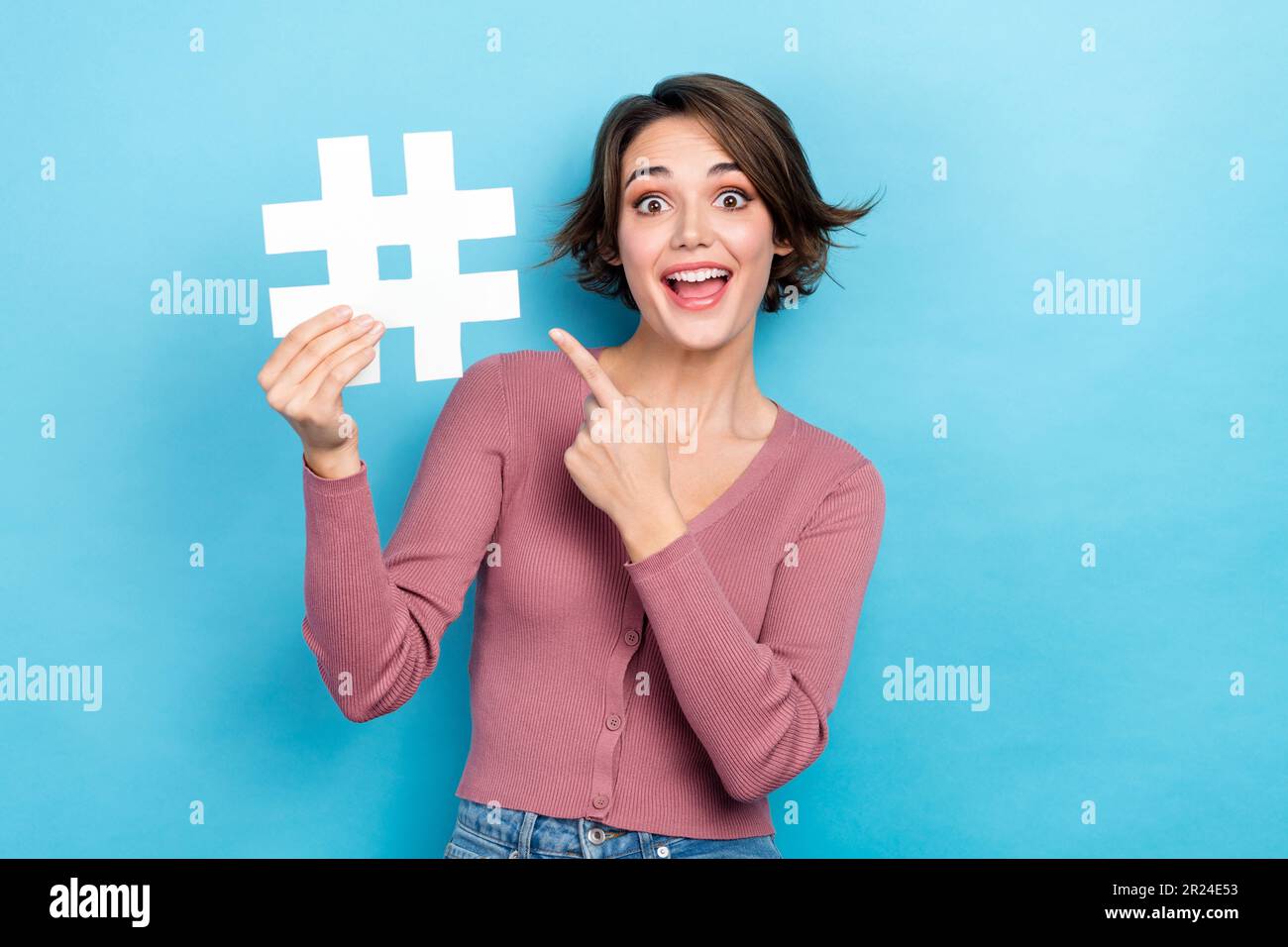 Photo of sweet impressed woman dressed pink shirt pointing finger hash ...