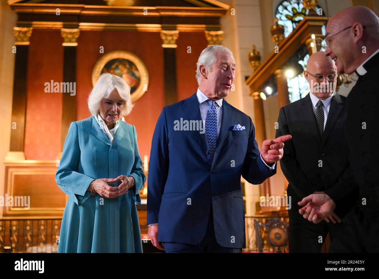 King Charles III and Queen Camilla speak Reverend Simon Grigg (right ...