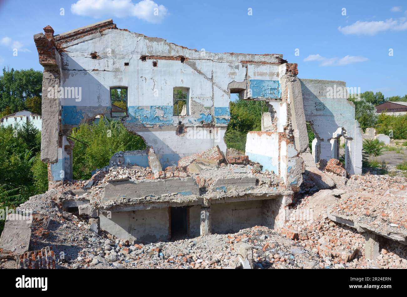 Collapsed industrial multistorey building in daytime. Disaster scene ...