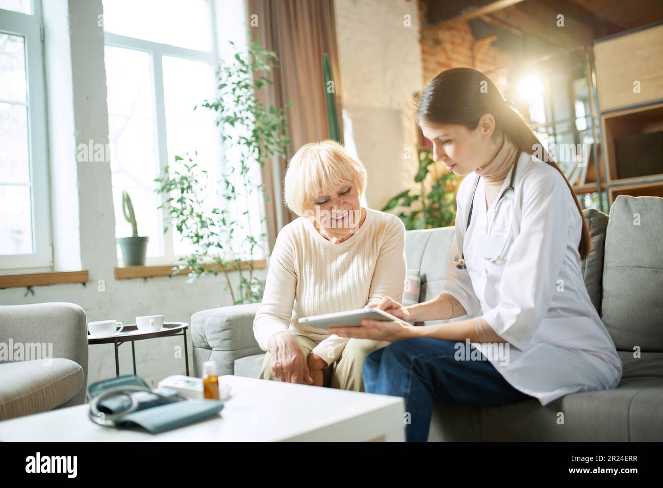 Senior smiling woman at doctor appointment, consultation checking ...