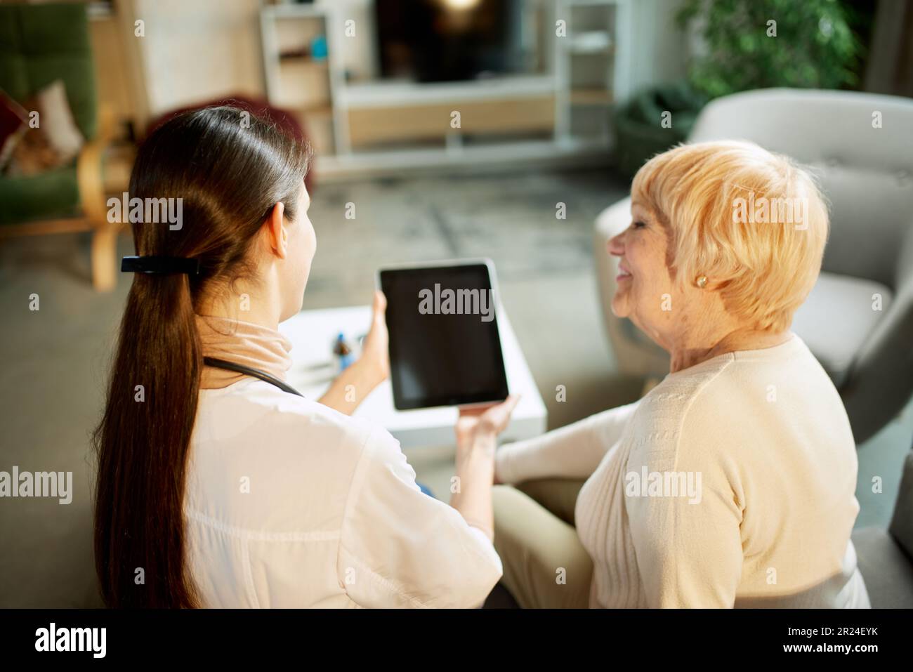 Young woman, doctor using tablet for personal information about ...