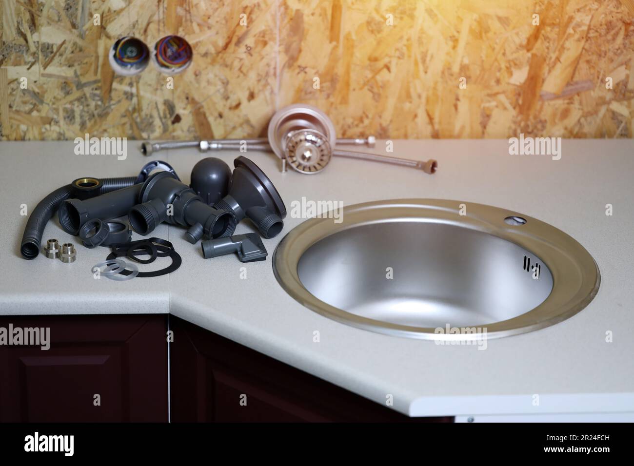Plumbers tools and water tap ready for installation near sink on ...